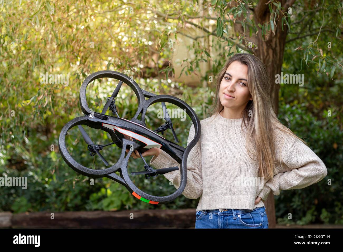 Backlit portrait of a Caucasian girl showing to the camera her new ...