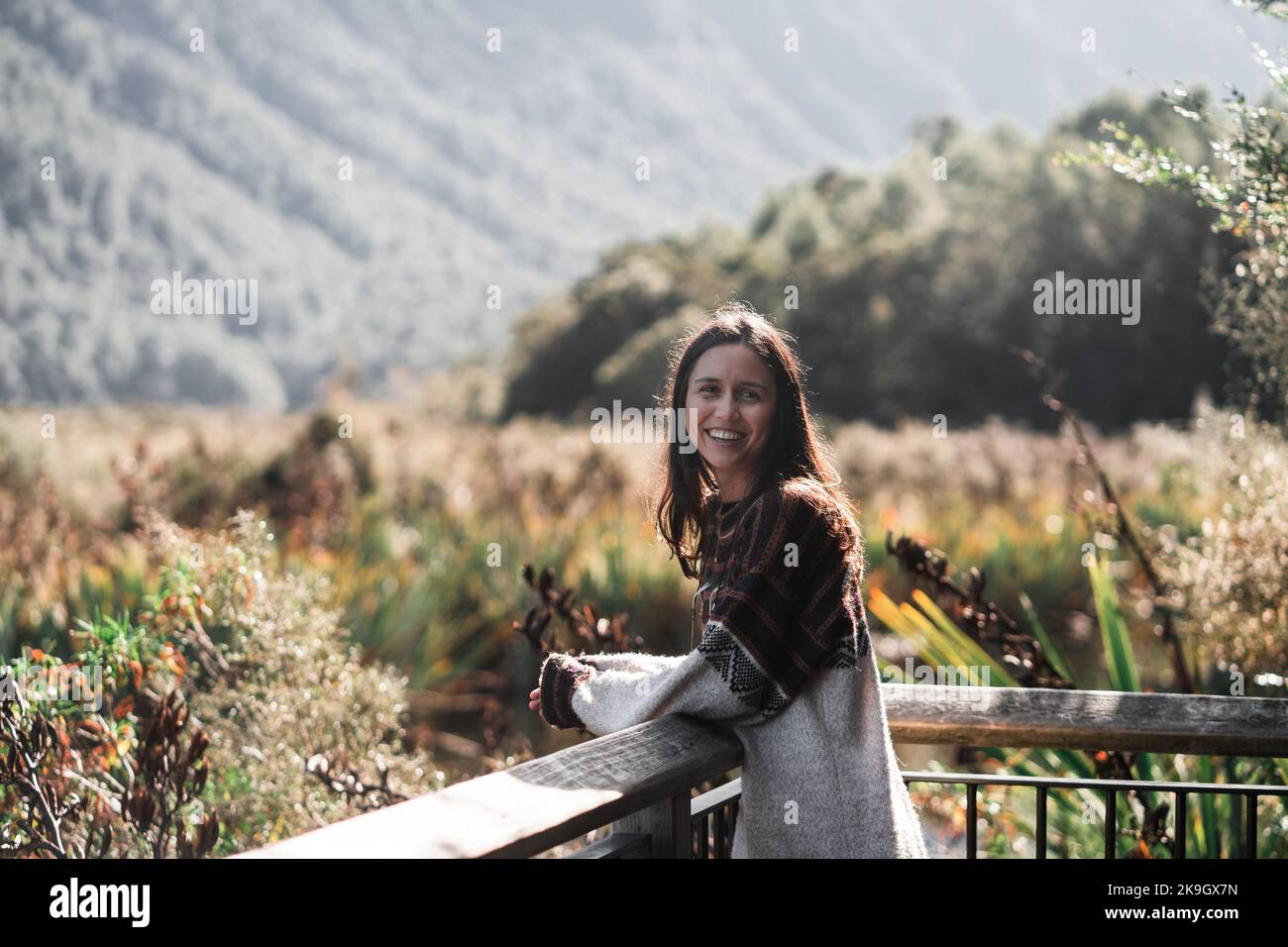 caucasian young woman with long disheveled hair in wool sweater leaning ...