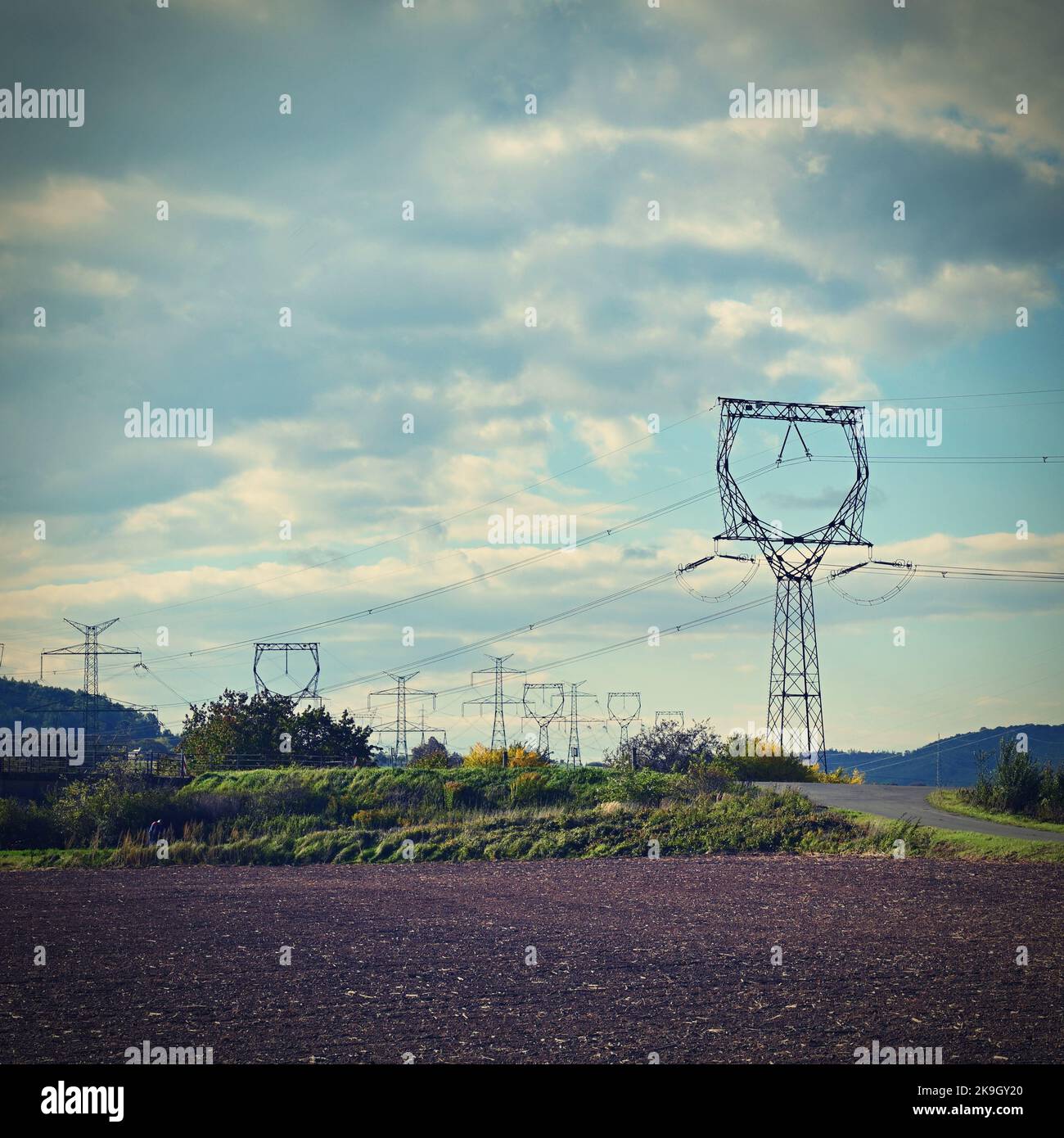 High voltage pylons - Blue sky with clouds and sun in nature. Concept ...