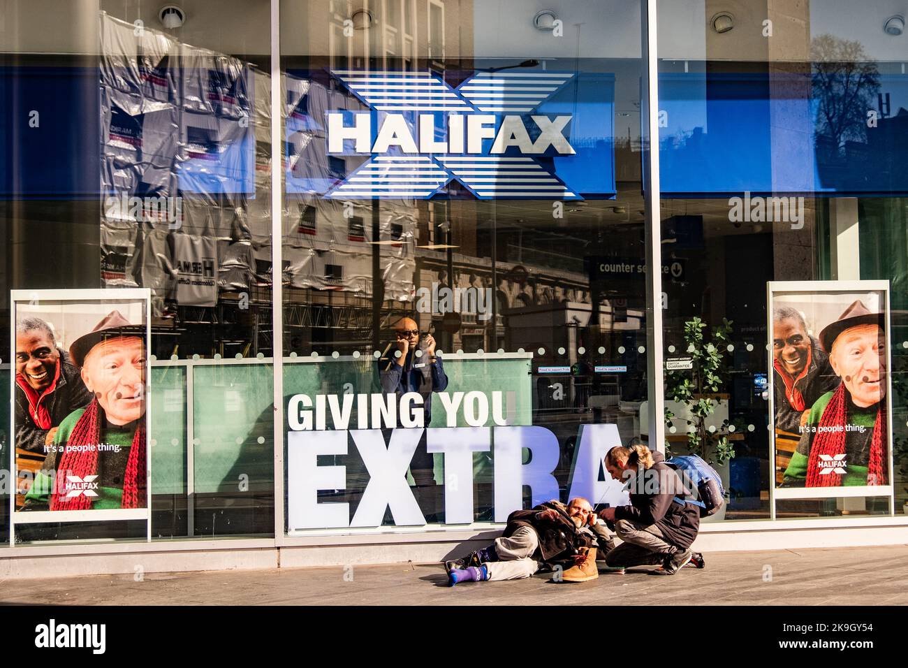 London- May 2022: A homeless man on the floor outside Halifax bank in ...