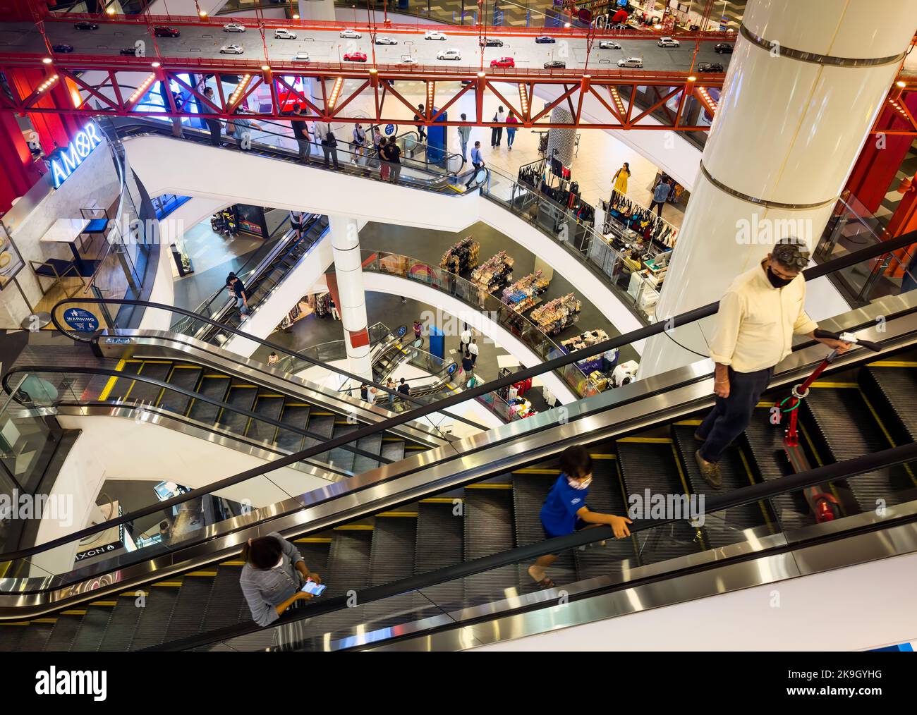 People ride the escalators next to a model of the Golden Gate Bridge in ...
