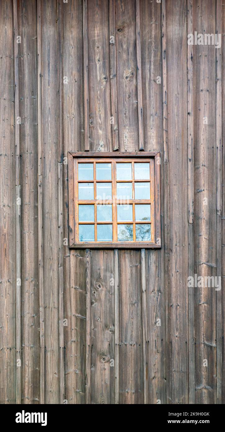 A small window with muntins against the background of a wall covered ...