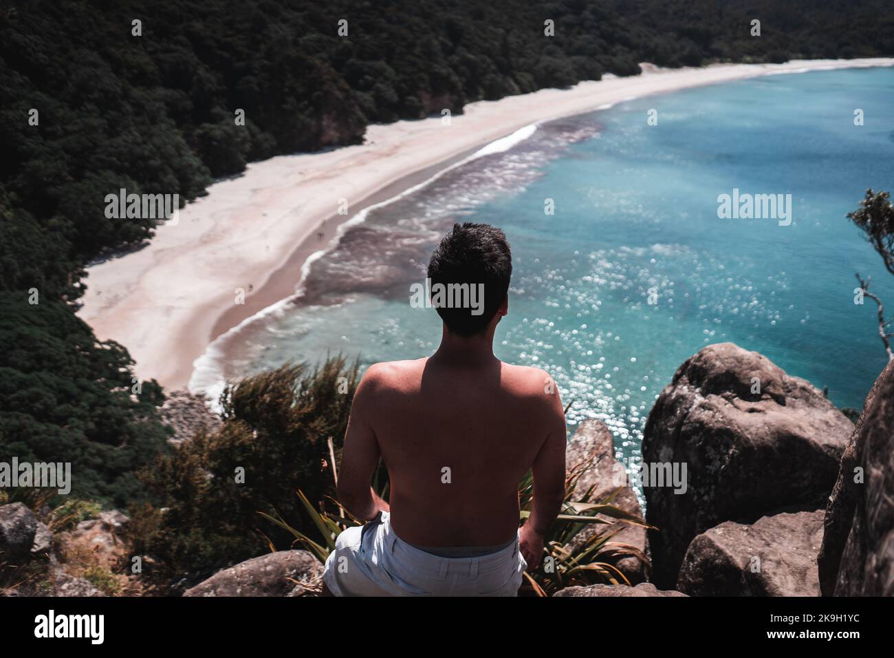 young man from behind on new chums beach Stock Photo - Alamy