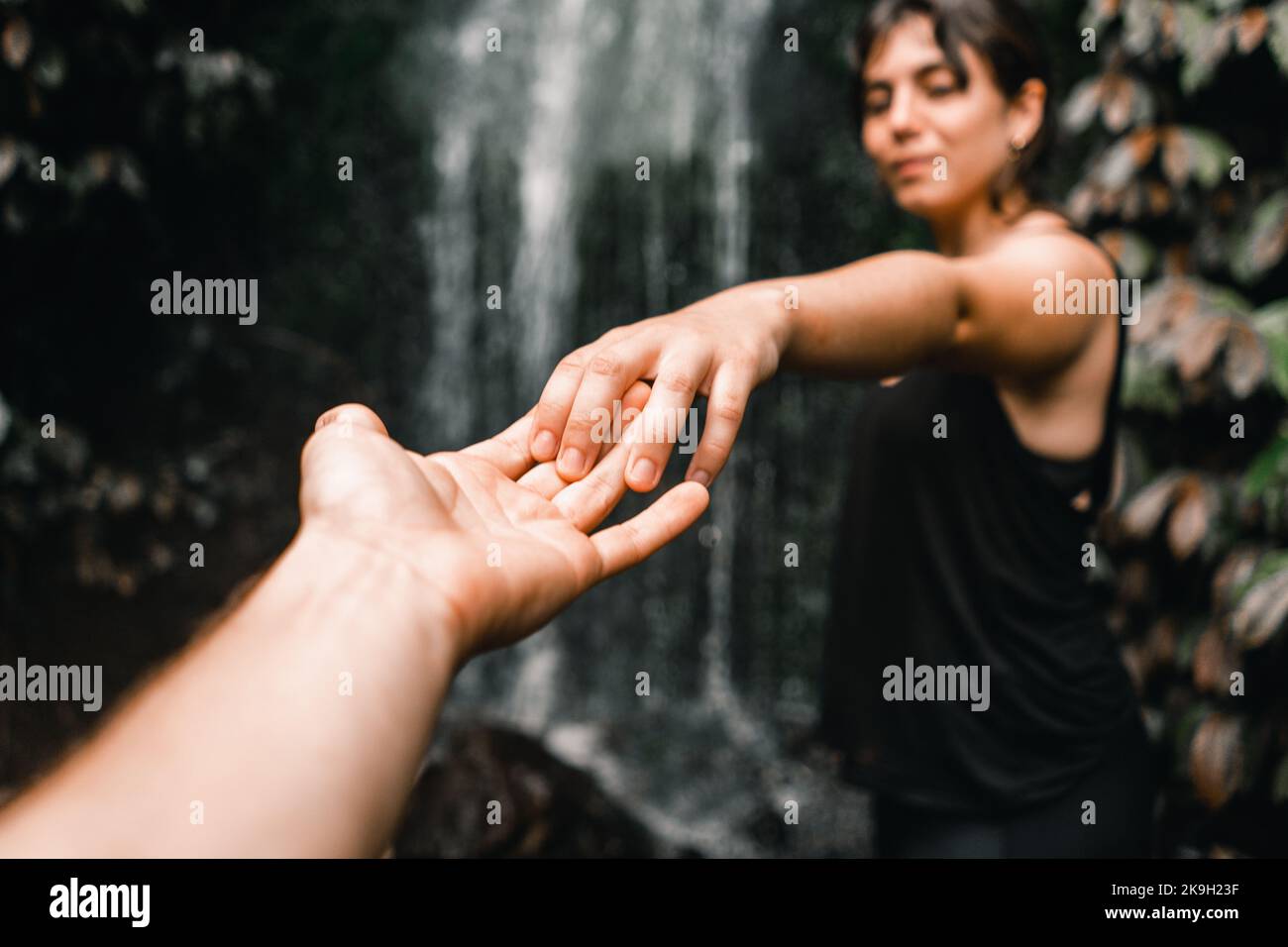 young caucasian boy and girl putting their arms outstretched together ...