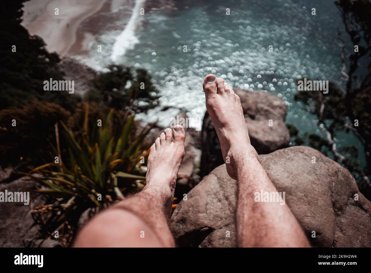 boy's feet dangling over new chums beach Stock Photo - Alamy