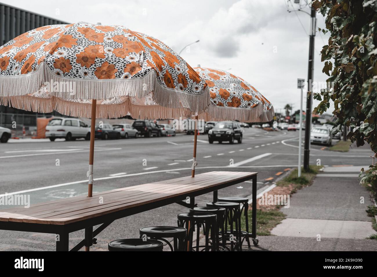 umbrellas on the outside table of a restaurant on the street Stock ...