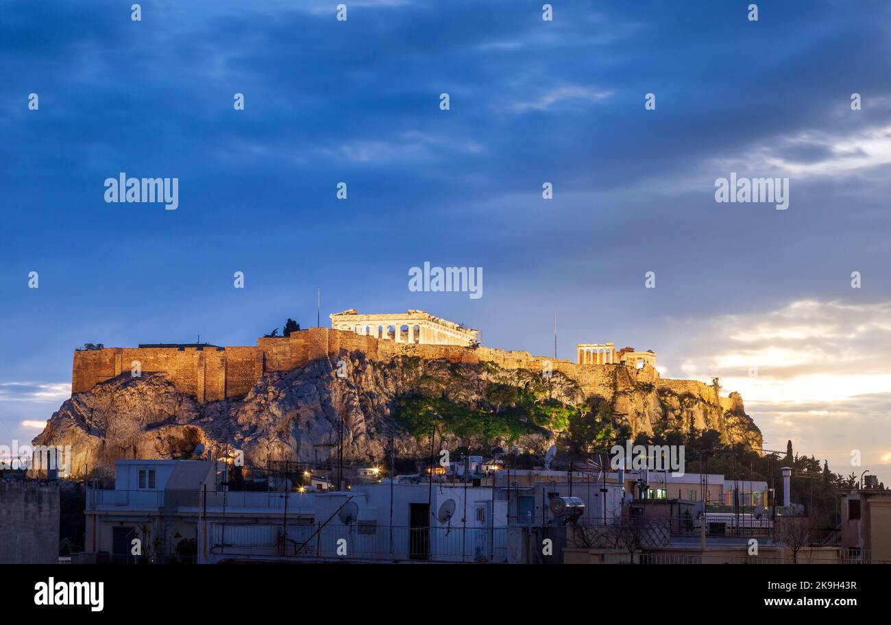 Amazing sunset view of the Acropolis and the ancient Parthenon temple, with urban foreground, in ...