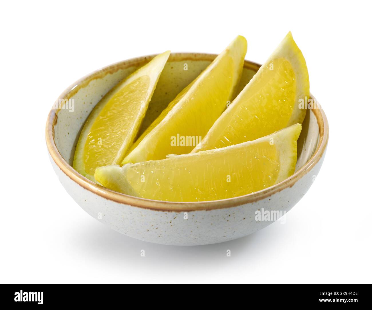 bowl of fresh lemon slices isolated on white background Stock Photo - Alamy