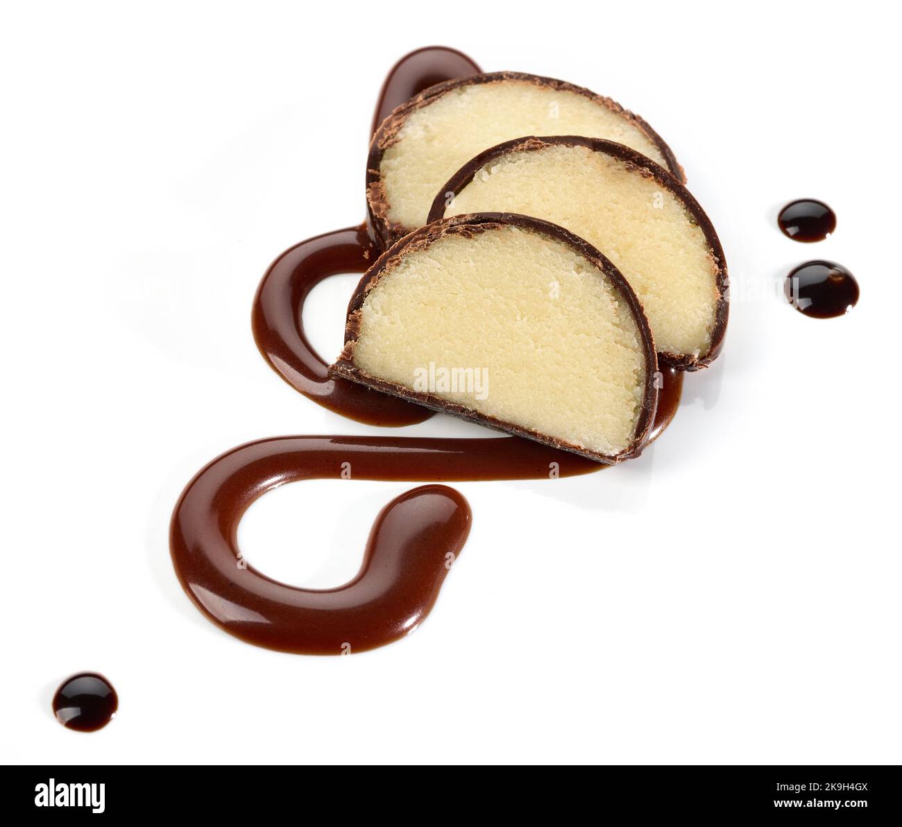 pieces of marzipan and chocolate sauce isolated on white background ...