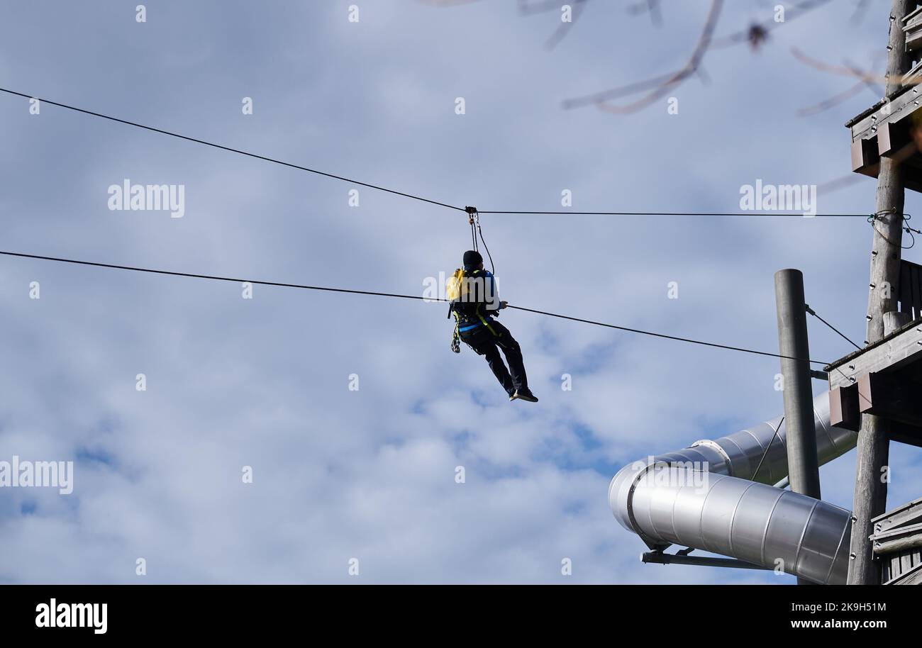 St. Englmar, Germany. 28th Oct, 2022. A man hangs secured in the air in ...