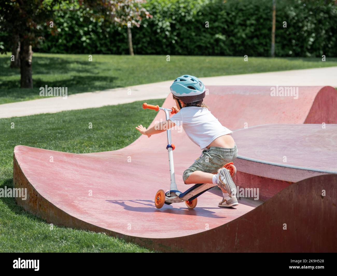Little boy fell off kick scooter while riding in skate park. Special ...