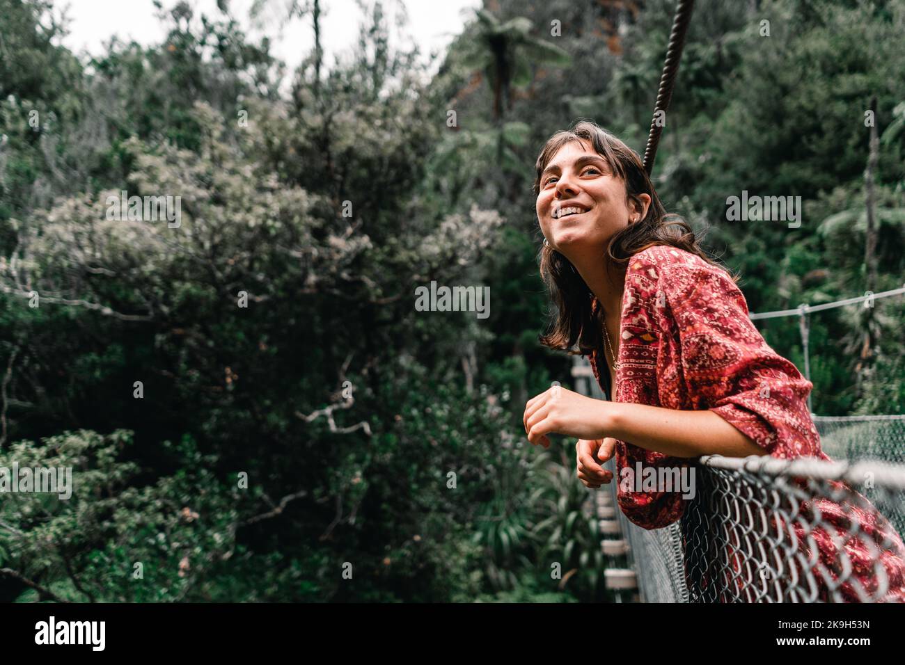 caucasian girl with white teeth and disheveled hair in thin red jacket ...