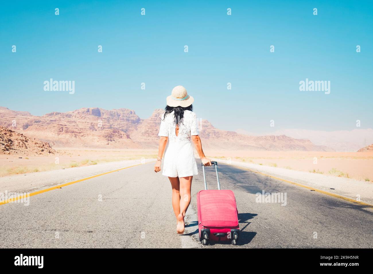 Back view young carefree caucasian traveler tourist on road walk drag ...