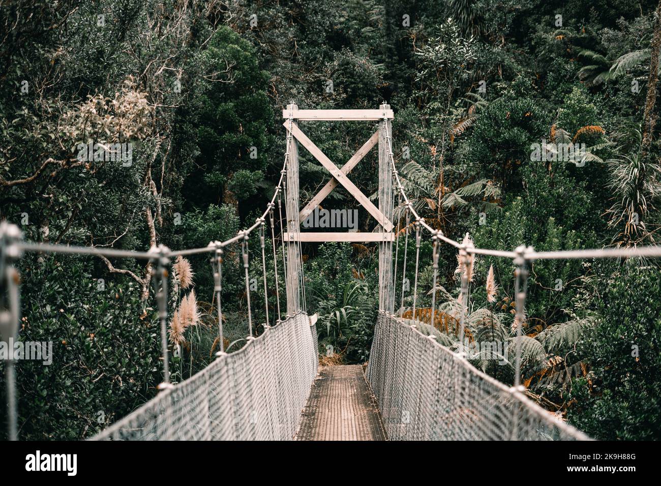 long narrow old bridge with the pillars and wooden floor fastened with ...