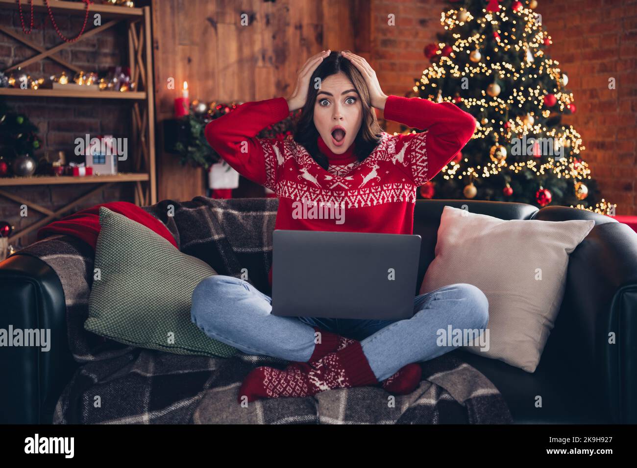 Full length photo of impressed speechless person sit sofa hands touch ...