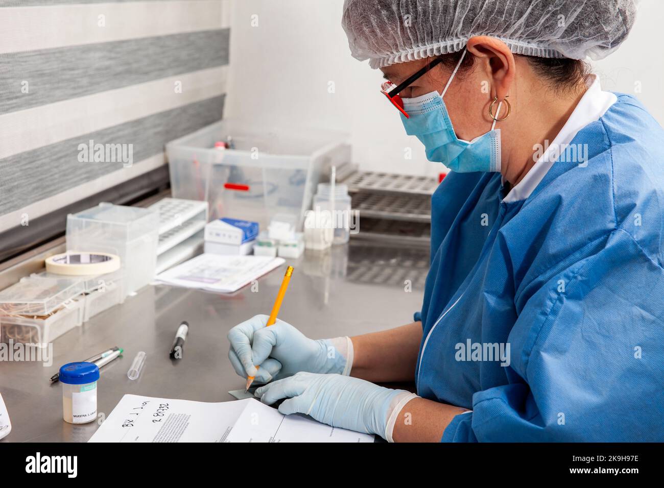 Laboratorian giving admission to pap smear samples in the laboratory ...