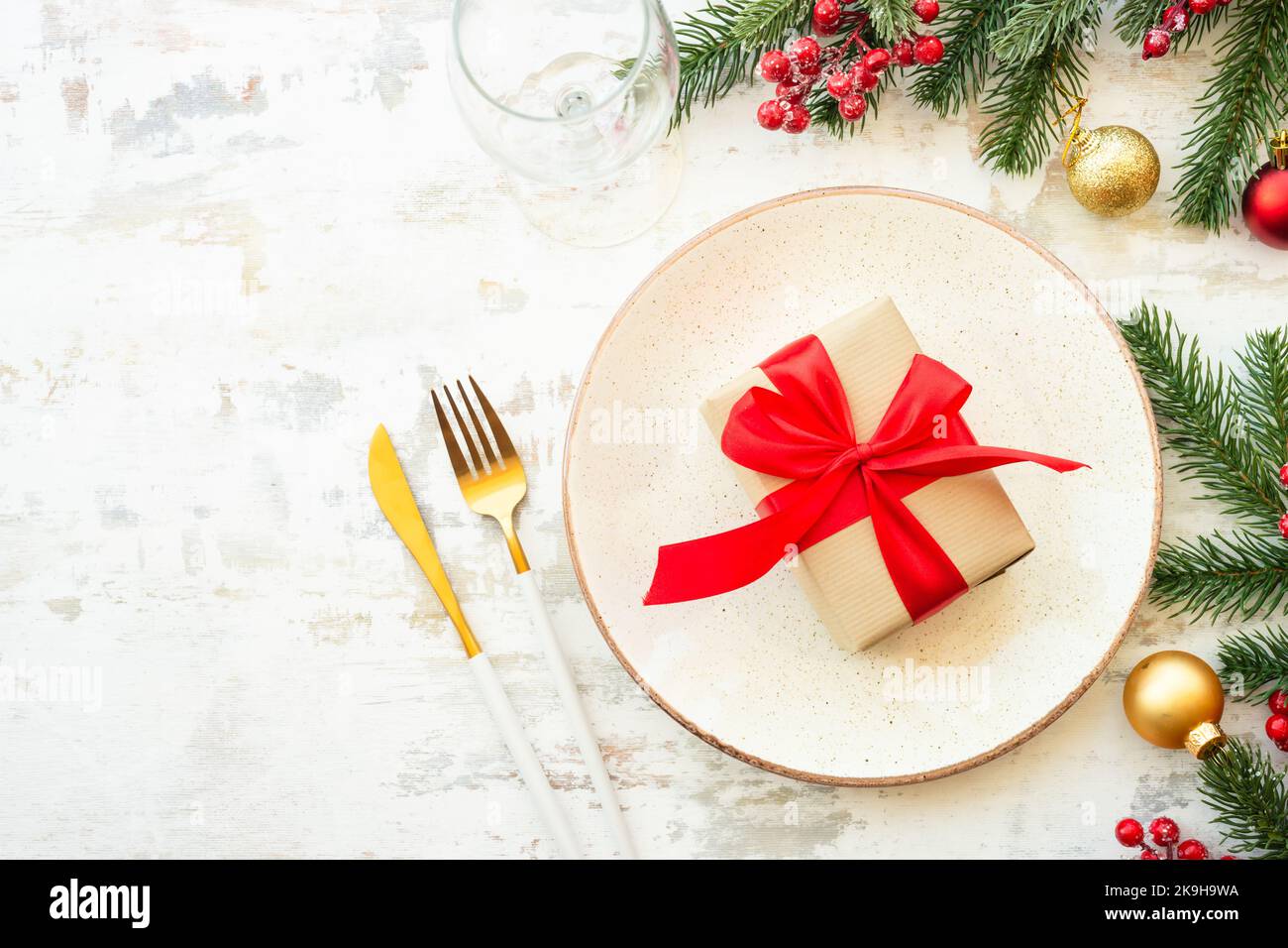 Christmas table setting with plate, cutlery and christmas decorations ...