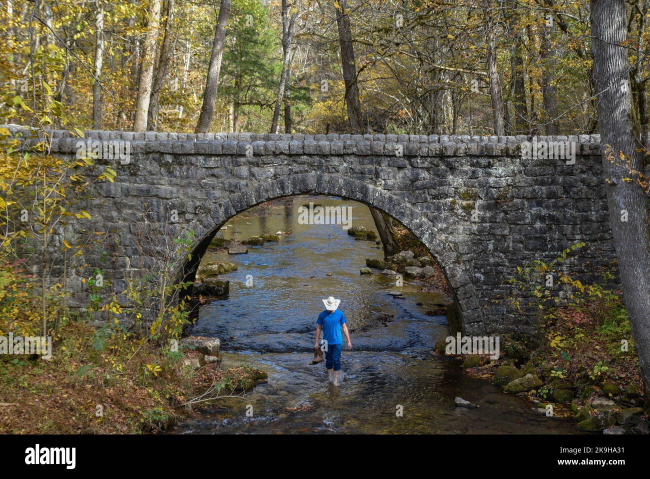 picture of a person walking under a bridge Stock Photo - Alamy