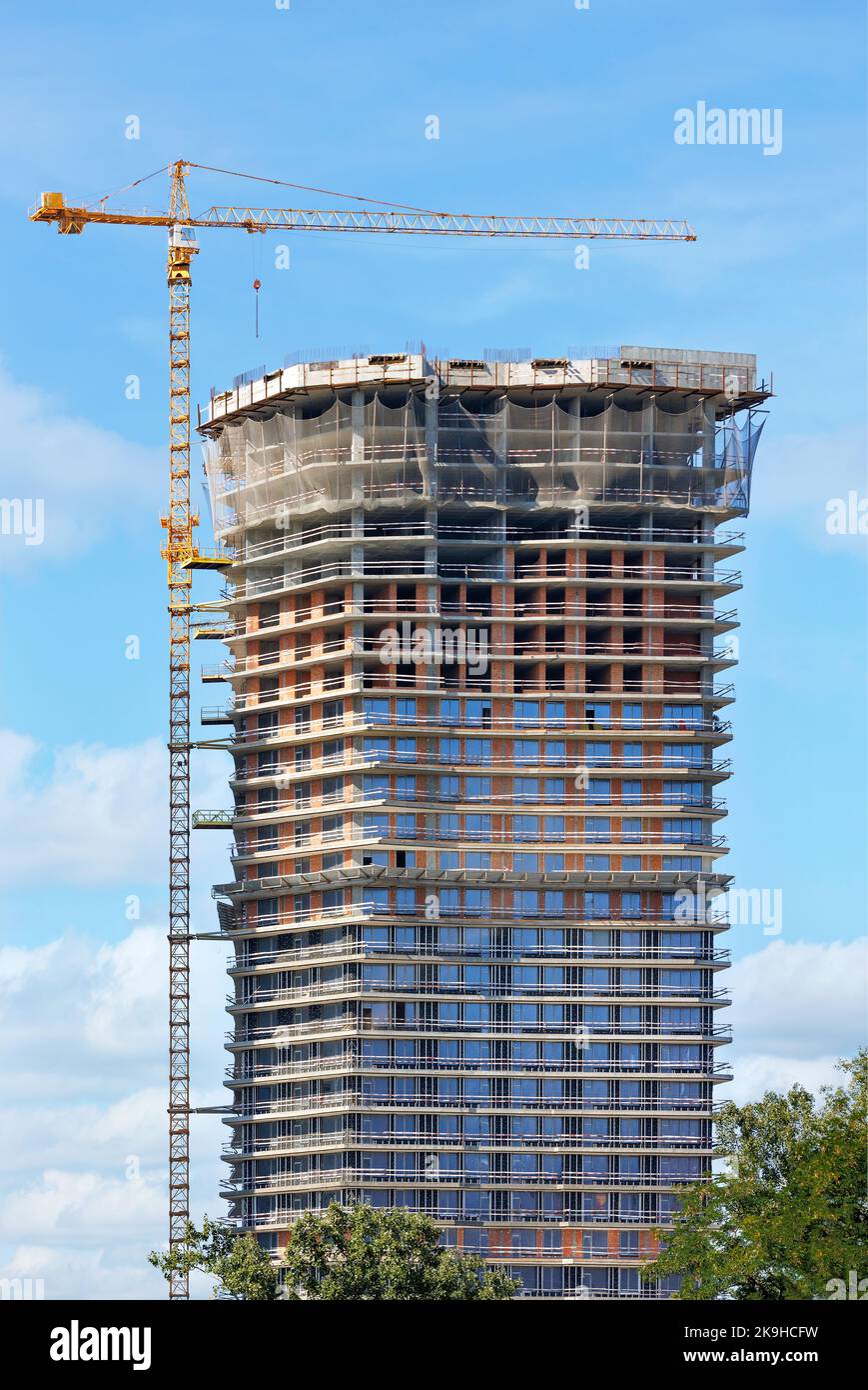 Modern construction of a multi-storey skyscraper with a tower crane on ...