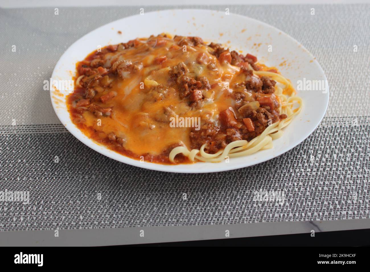 Messy plate with spaghetti full of sauce Stock Photo - Alamy