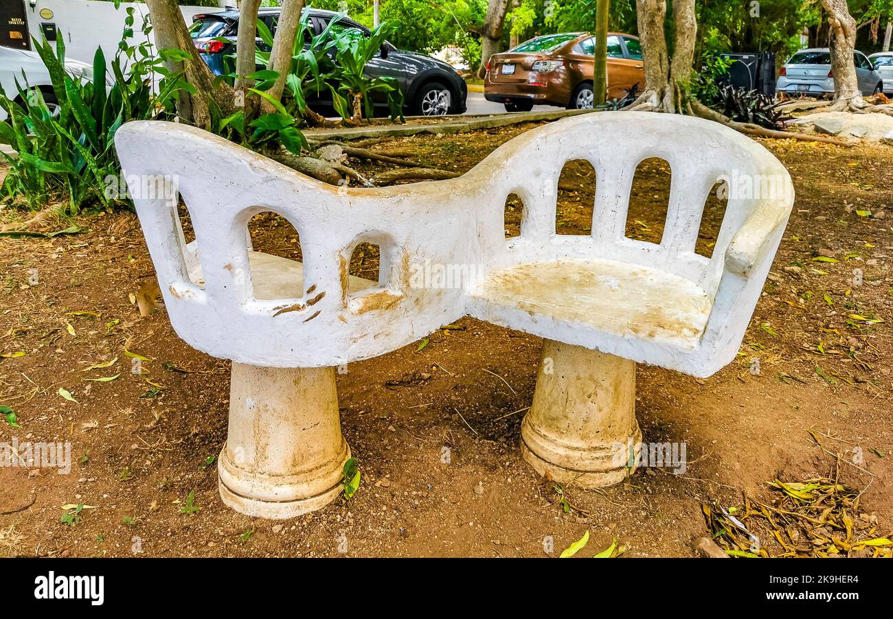 Artfully curved stone bench in the city park in Playa del Carmen ...