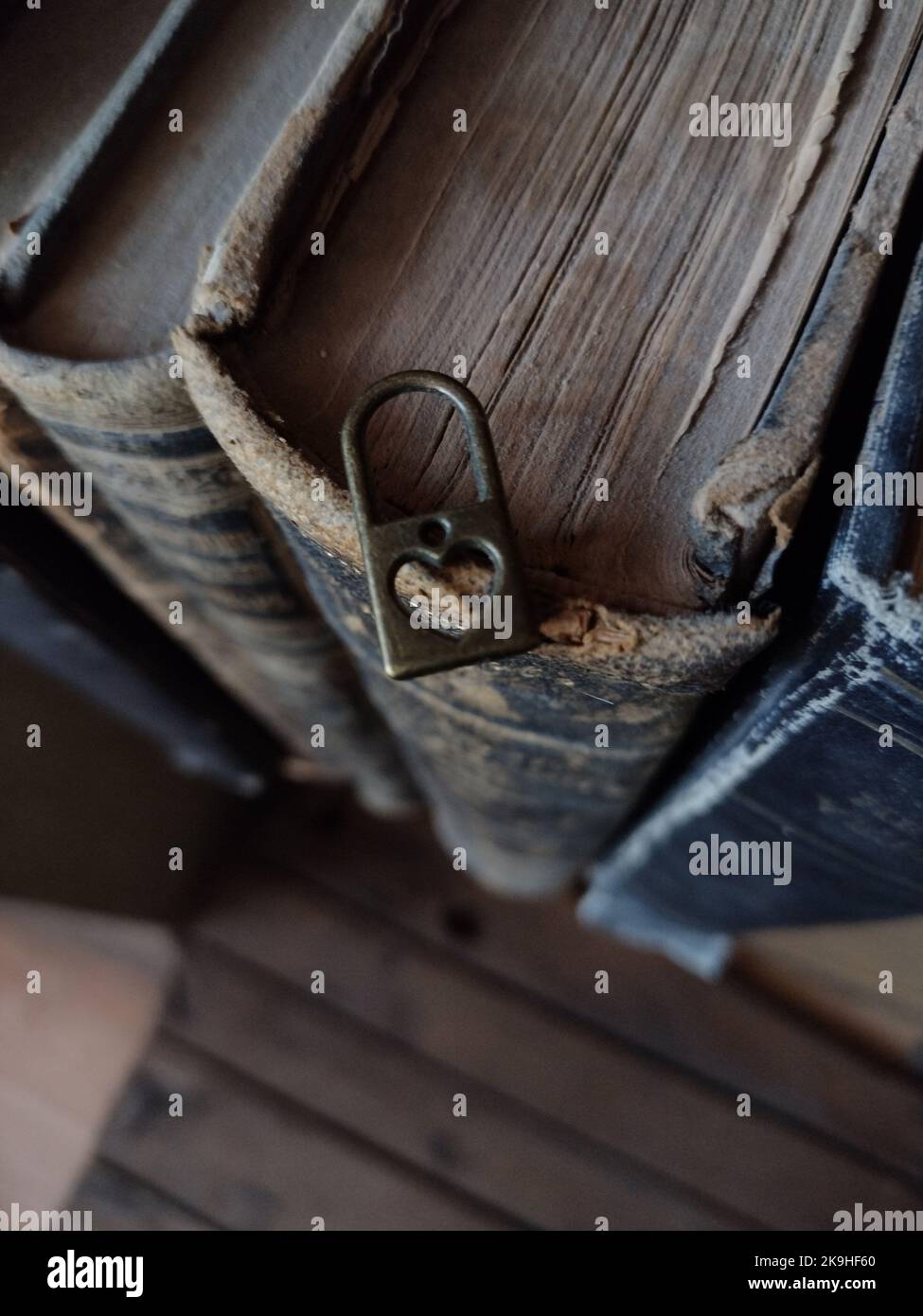 Romantic background. Lock with a heart on old books Stock Photo - Alamy