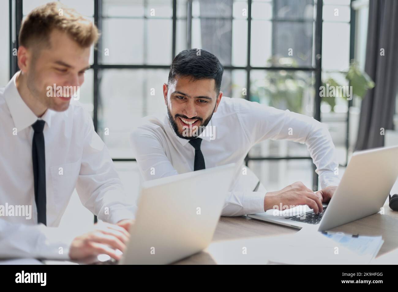 Two happy men working together on a new business project Stock Photo ...