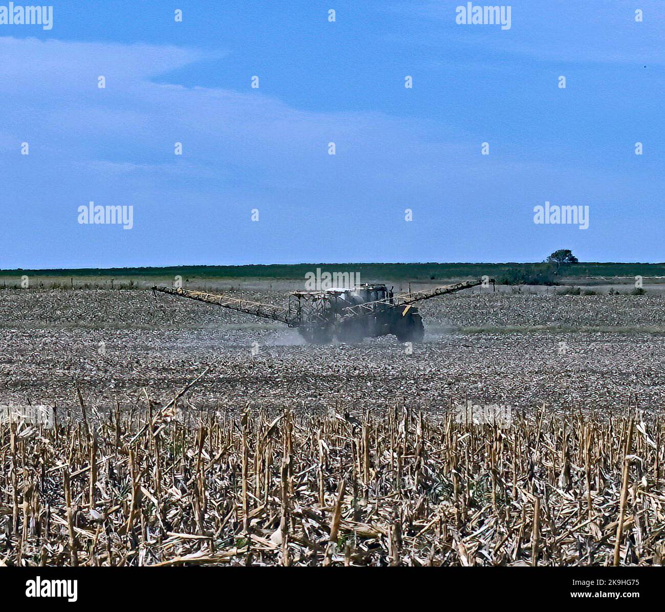 CANTON, KANSAS - SEPTEMBER 19, 2022Farm worker spraying a recently cut ...