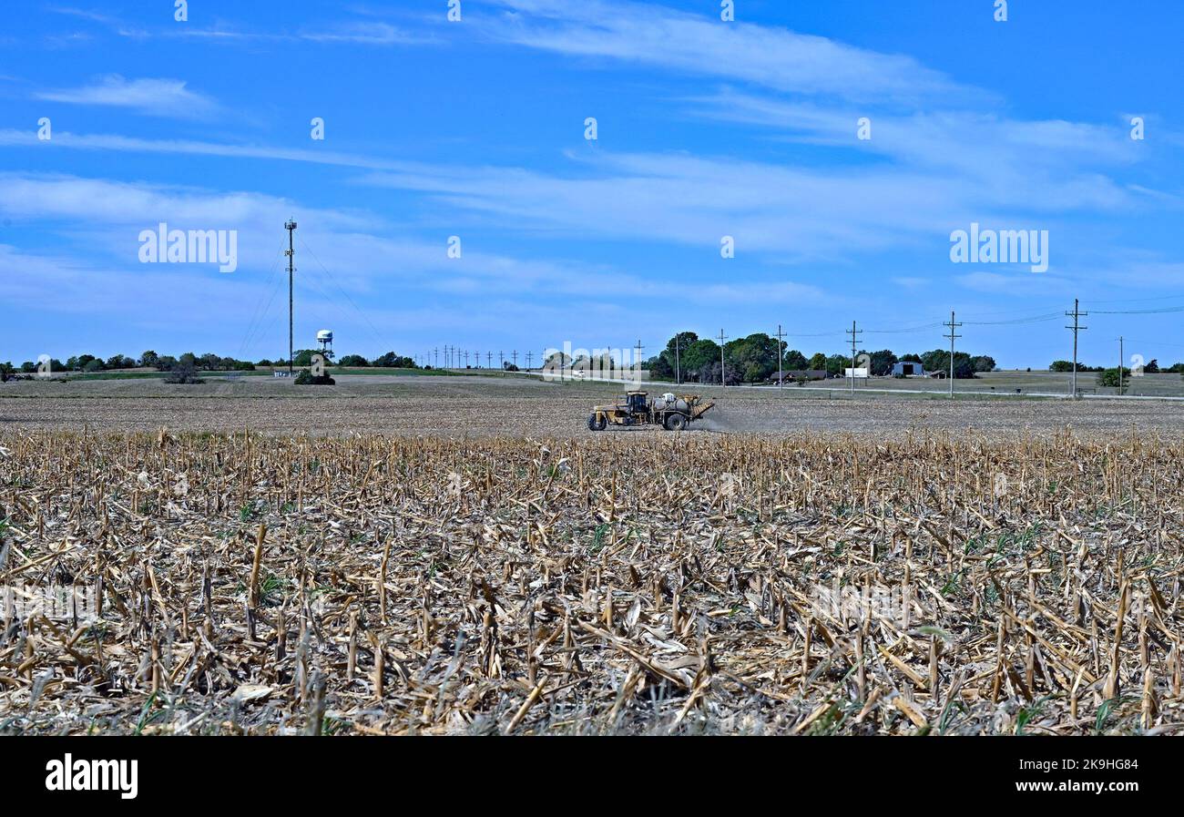 CANTON, KANSAS - SEPTEMBER 19, 2022Farm worker spraying a recently cut ...