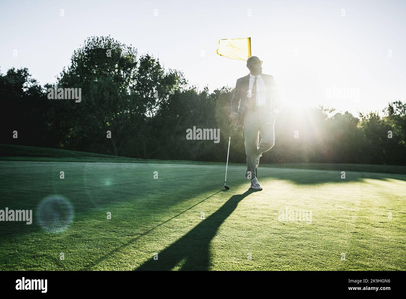 A dapper bald bearded black man in an elegantly tailored suit with a ...