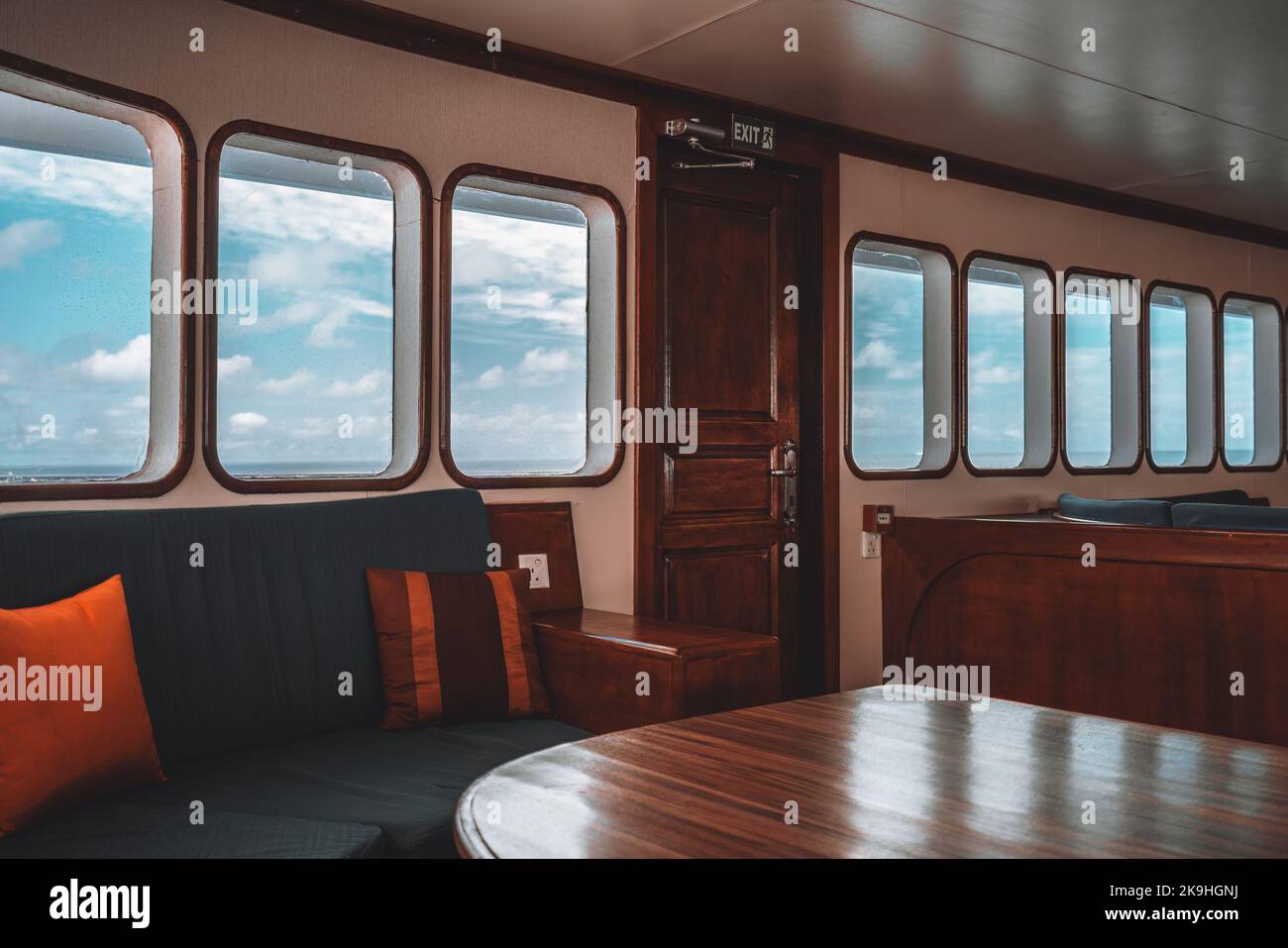 A row of windows with an exit door leading to a deck of a safari yacht ...