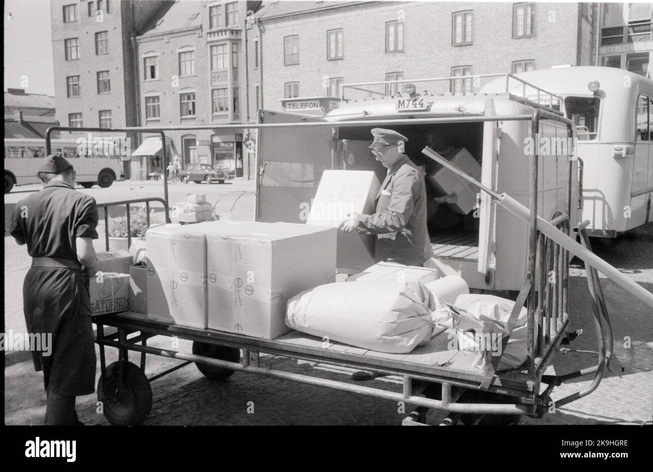 Mail packages are loaded between bus trailers and carts Stock Photo - Alamy