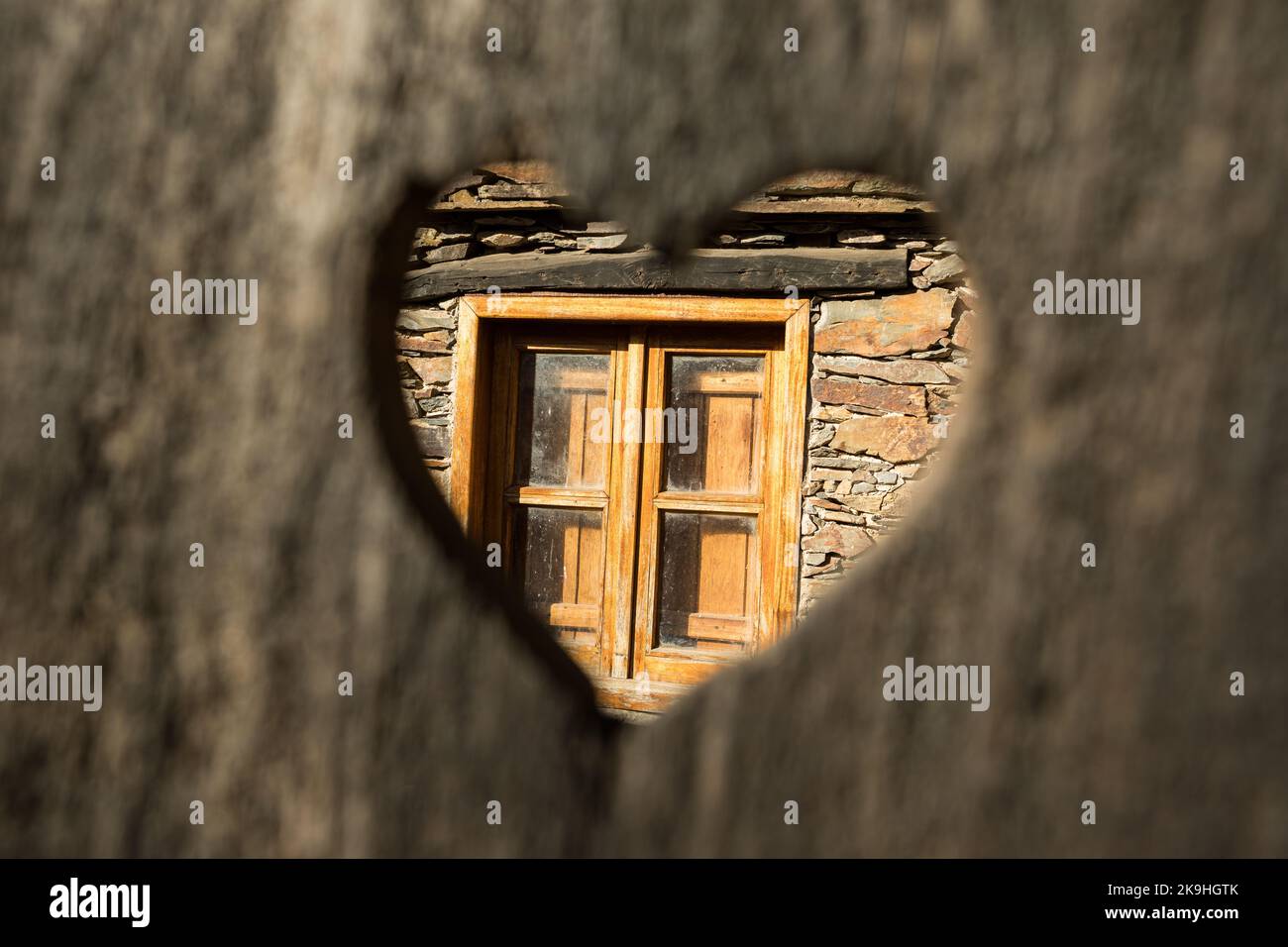 Door with a heart shaped small hole with a wooden window in the ...