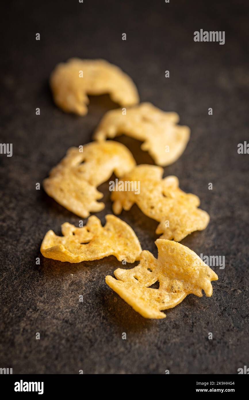 Halloween crispy bat shaped chips on the dark table Stock Photo - Alamy