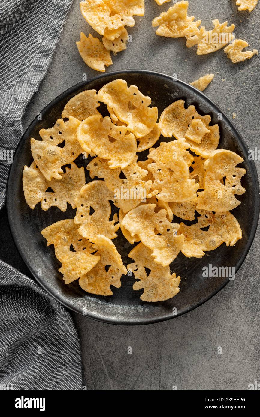 Halloween crispy bat shaped chips on the plate. Top view Stock Photo ...