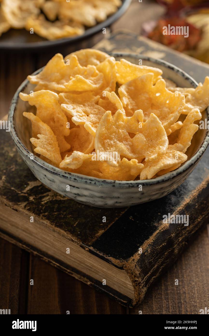 Halloween crispy bat shaped chips in the bowl Stock Photo - Alamy
