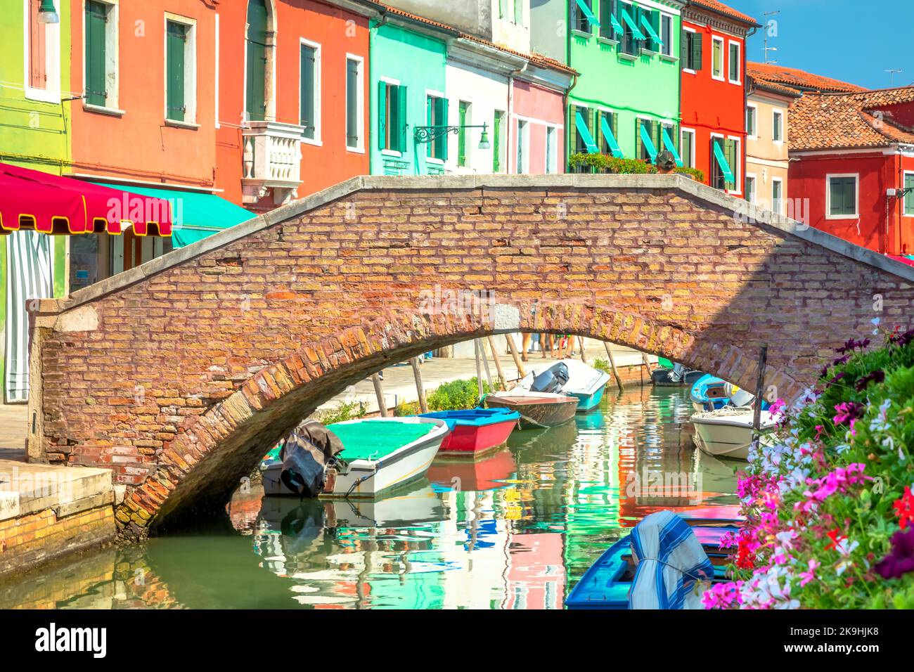 Footbridge above water canal in colorful Burano, Venice, Italy Stock ...