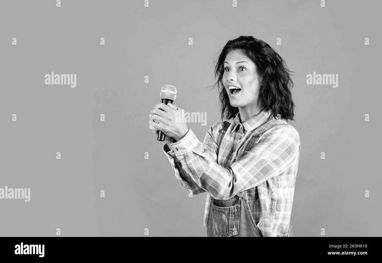 singing a song with a microphone. having a party. Happy woman with ...