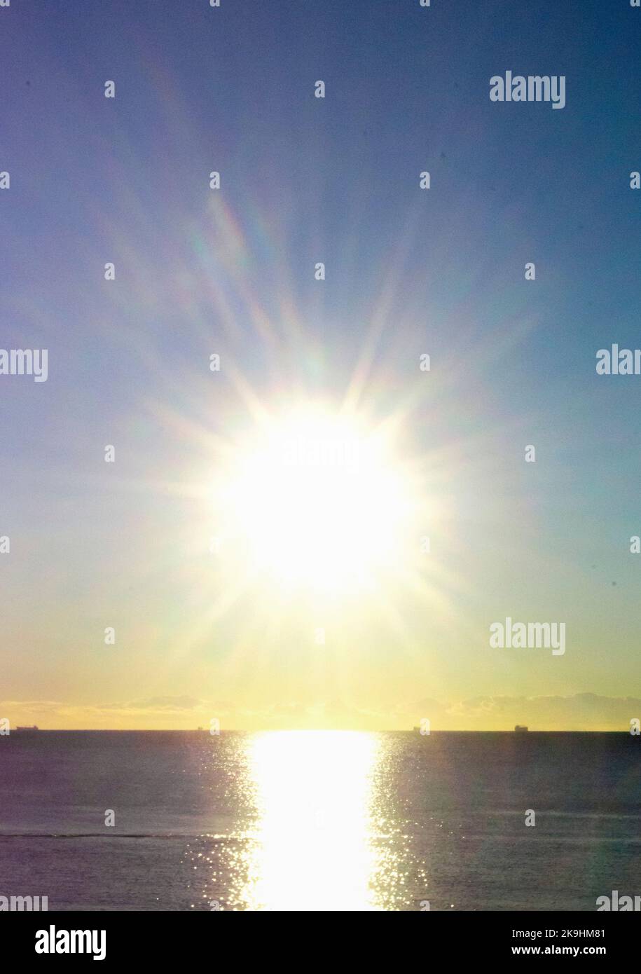 Blurred background. Sun shining in blue sky during sunset dawn. Sunrise ...