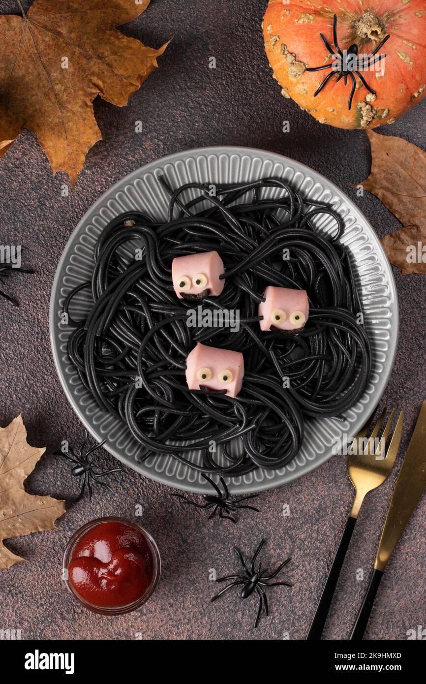 Funny black spaghetti spiders with sausages, breakfast or lunch idea ...