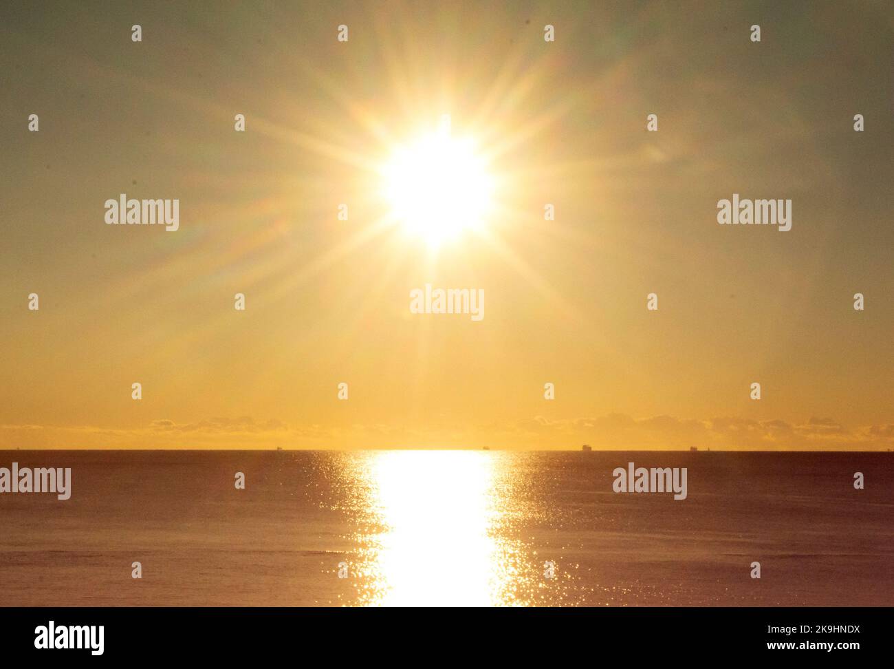 Blurred background. Sun shining in blue sky during sunset dawn. Sunrise ...