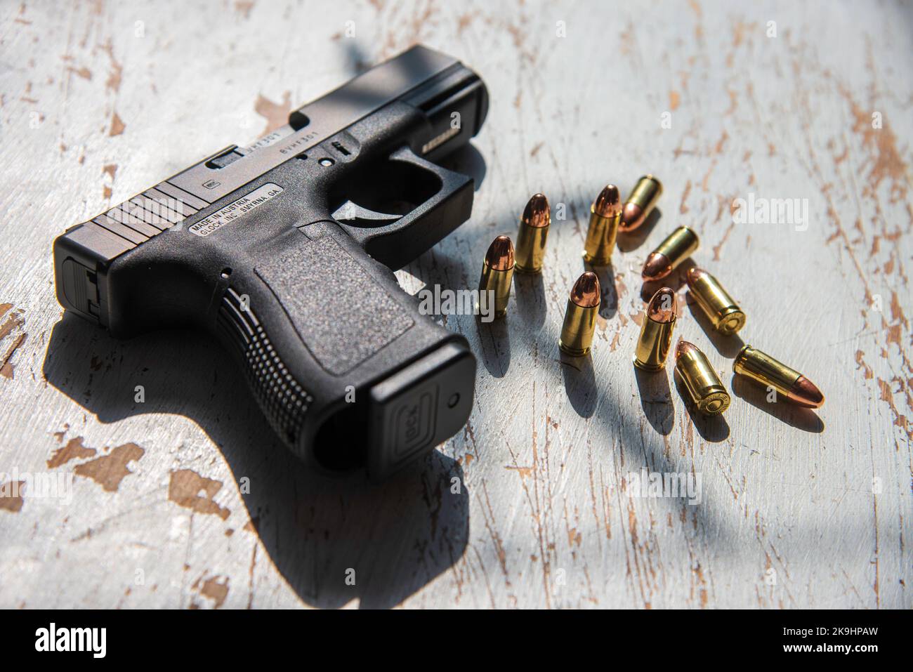 An Austrian-made, 9mm Glock 19, semi-automatic pistol resting on a wood ...