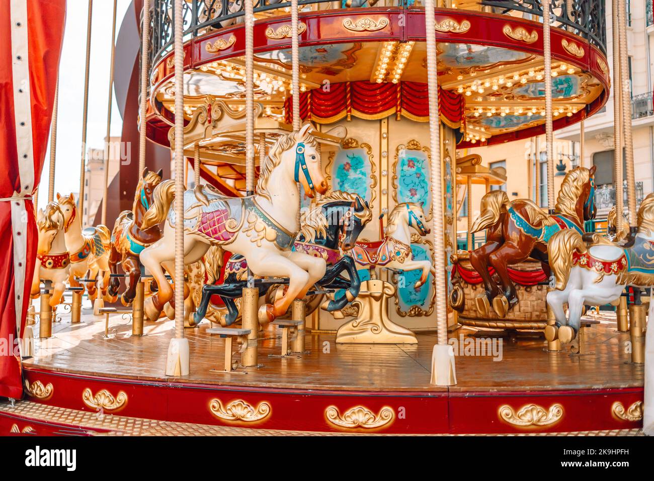 Old carousel in the park. Three horses and a plane on a traditional ...