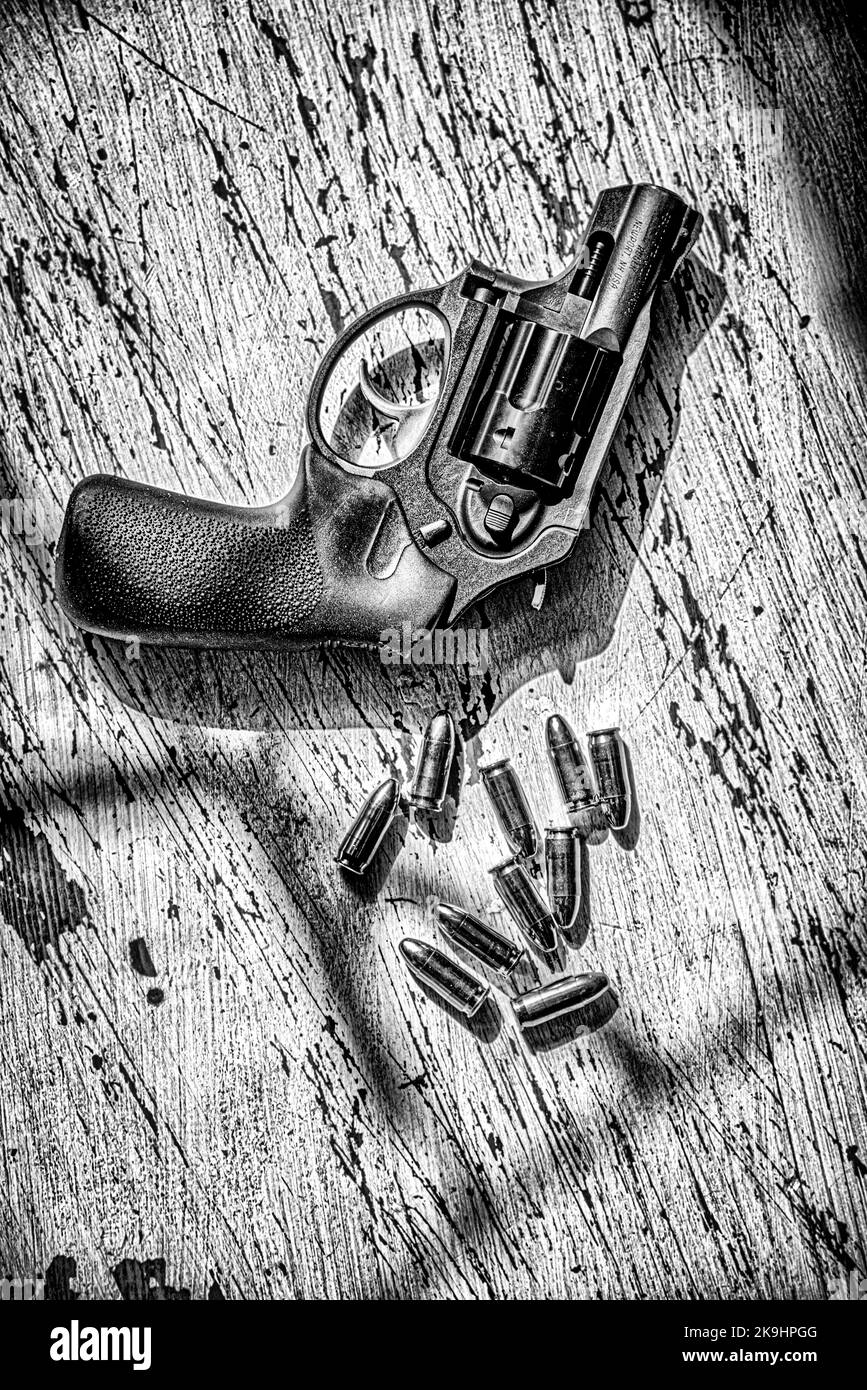 A black, Ruger, 9mm, snub-nosed revolver and a grouping of 9mm bullets ...