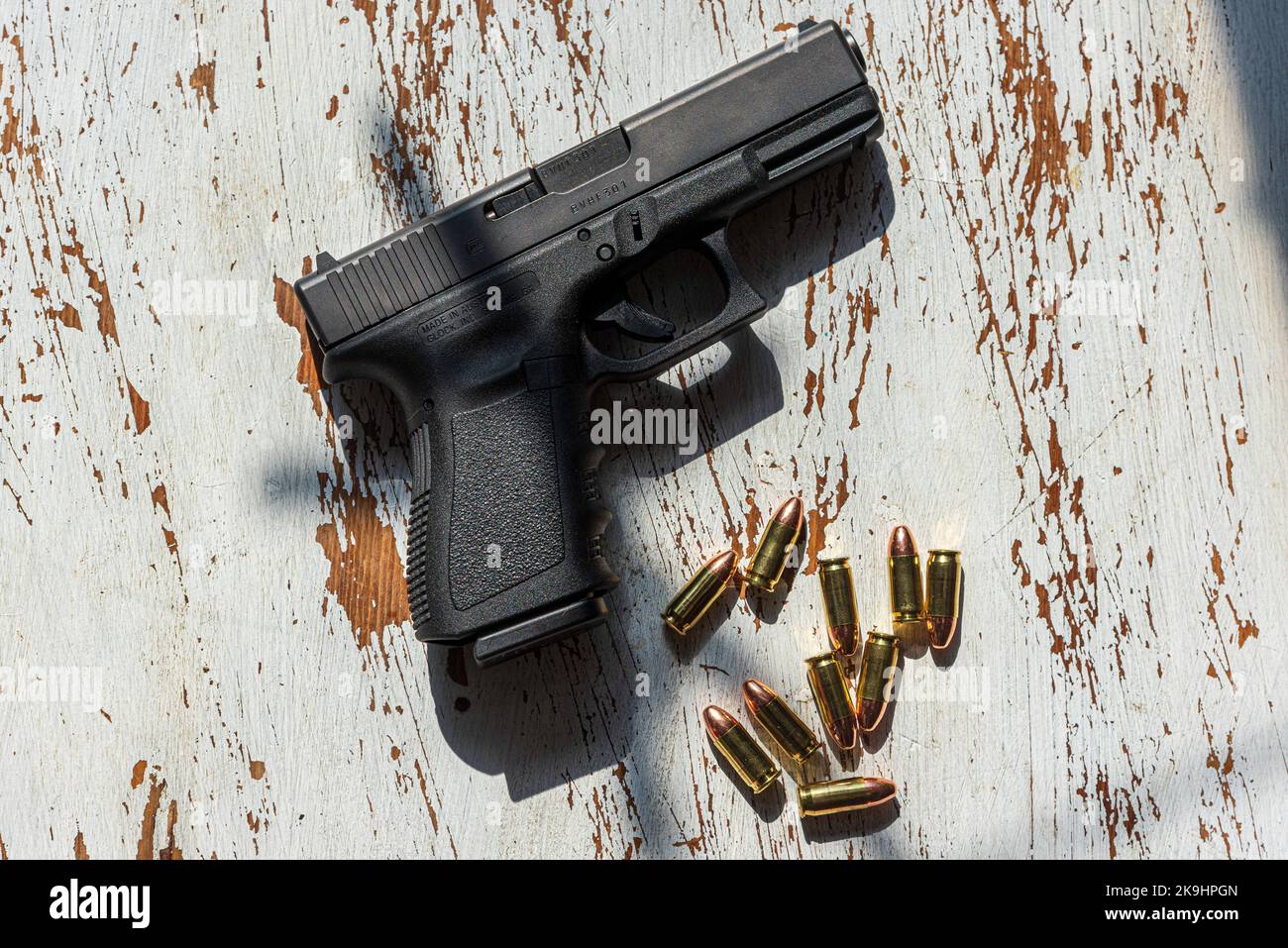 An Austrian-made, 9mm Glock 19, semi-automatic pistol resting on a wood ...
