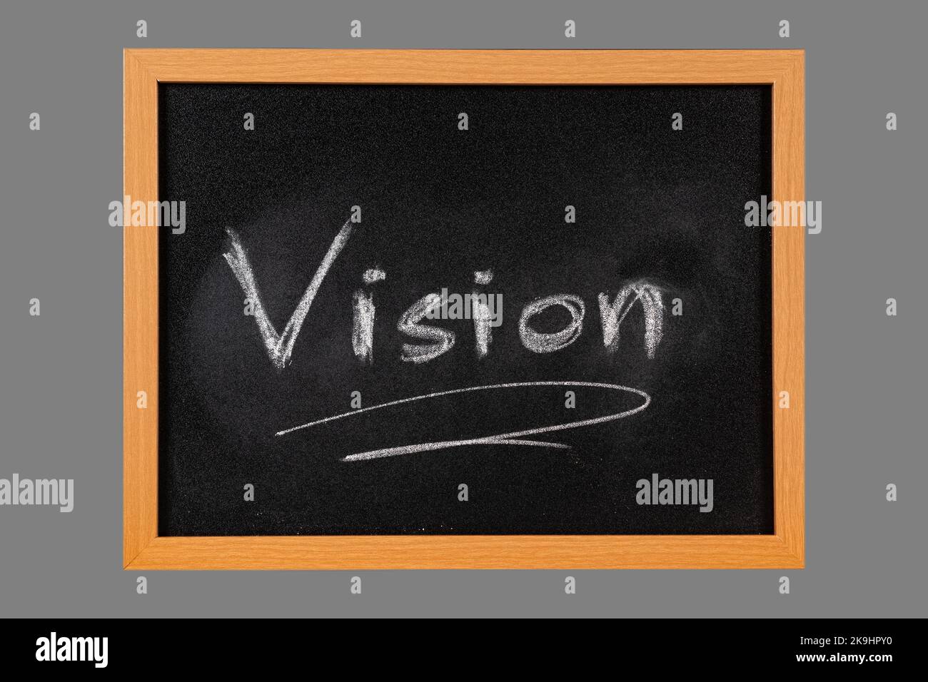 The word Vision handwritten with white chalk on blackboard with wooden ...