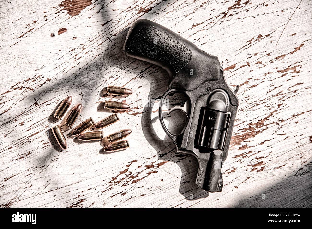 A black, Ruger, 9mm, snub-nosed revolver along with a grouping of 9mm ...