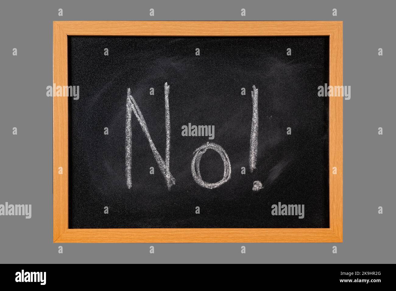 The word No handwritten with white chalk on blackboard with wooden ...