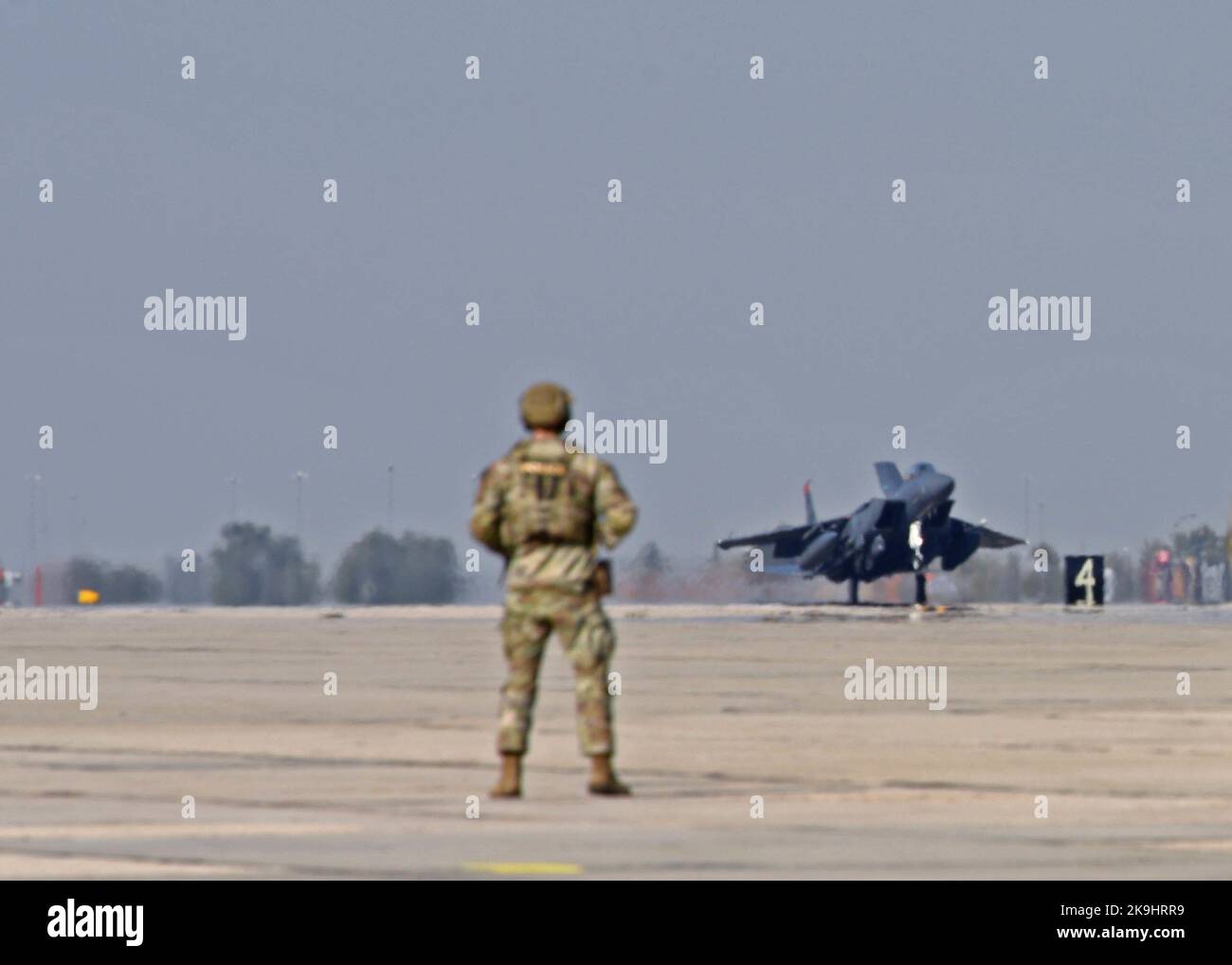 A U.S. Airman with the 366th Security Forces Squadron watches an F-15E ...
