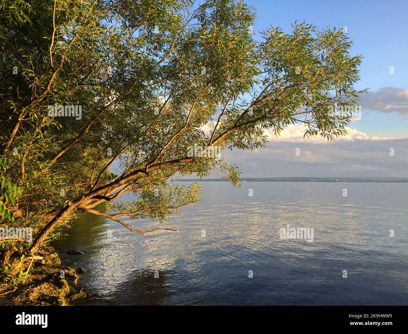 The east shore of Seneca Lake is colored gold by the setting Sun across ...